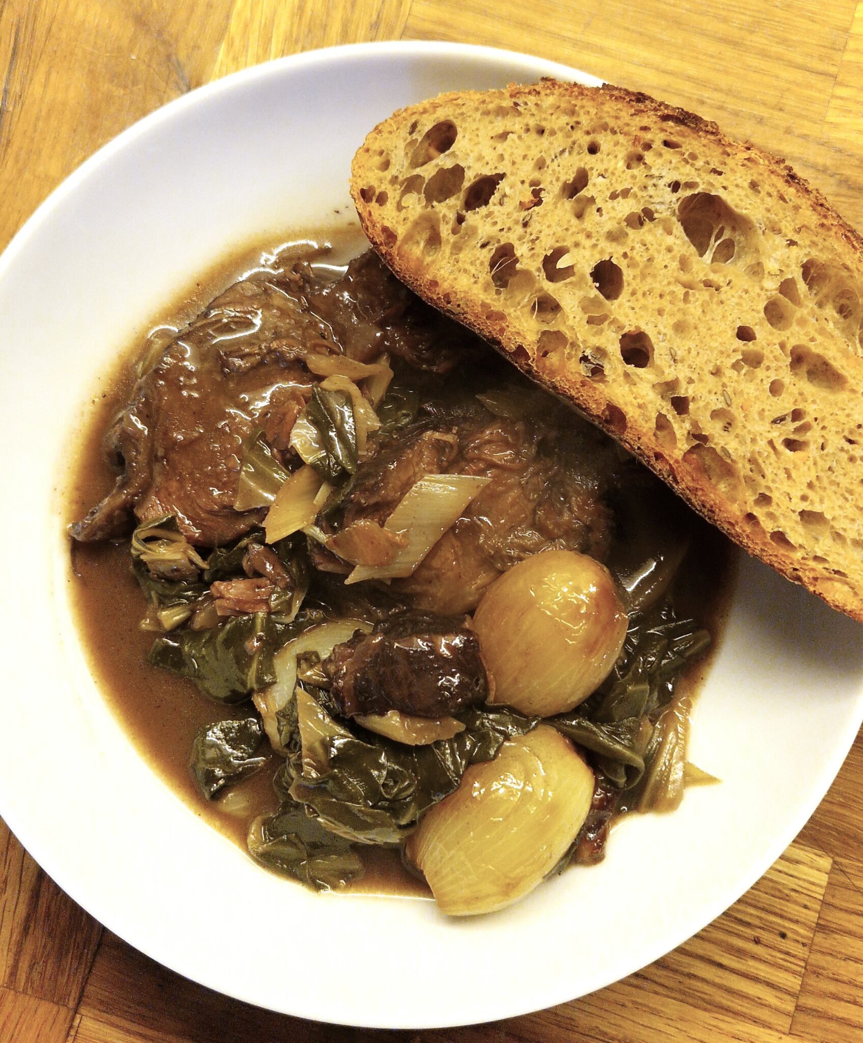Beef shoulder braised in red wine with green chard and pearl onions ...